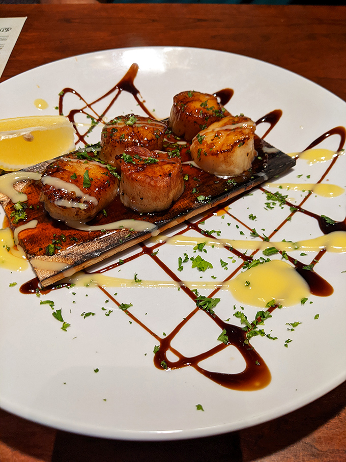 Scallops that look like they're performing a synchronized swimming routine in sauce. Culinary artistry at its most delectable.