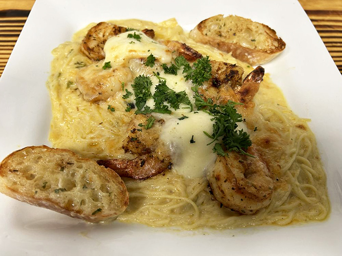Shrimp and pasta swimming in a creamy sea of alfredo, with garlic bread islands that beg to be used for sauce-mopping expeditions.