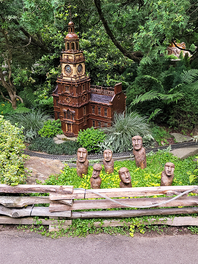 Independence Hall gets the dollhouse treatment while wooden faces stand guard. Honey, I shrunk Philadelphia and added whimsy!