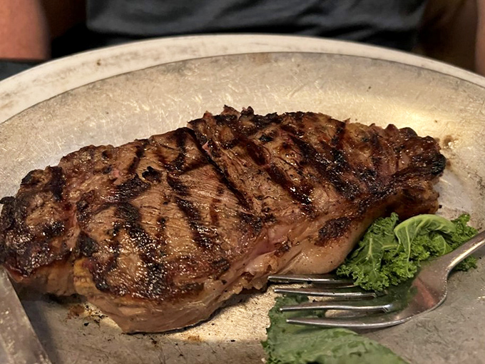 Char marks aren't just decoration; they're flavor geography. This steak has been to the promised land and brought back souvenirs.