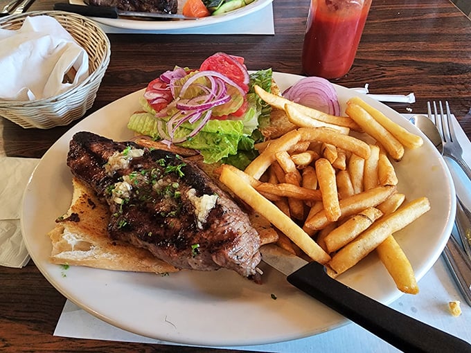 The legendary steak sandwich in all its glory&mdash;perfectly grilled beef on toasted bread with crispy fries and fresh garnish. Worth the drive from anywhere in California.
