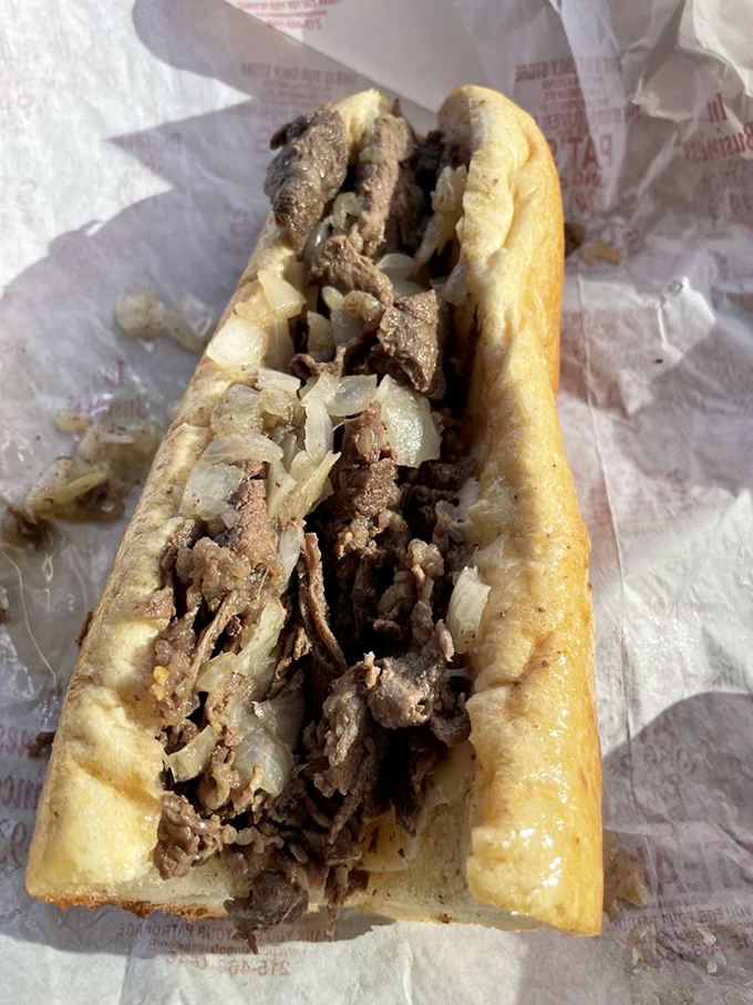 Simplicity perfected: thinly sliced beef and sweet onions nestled in that distinctive roll&mdash;the foundation of Pat's enduring legacy.