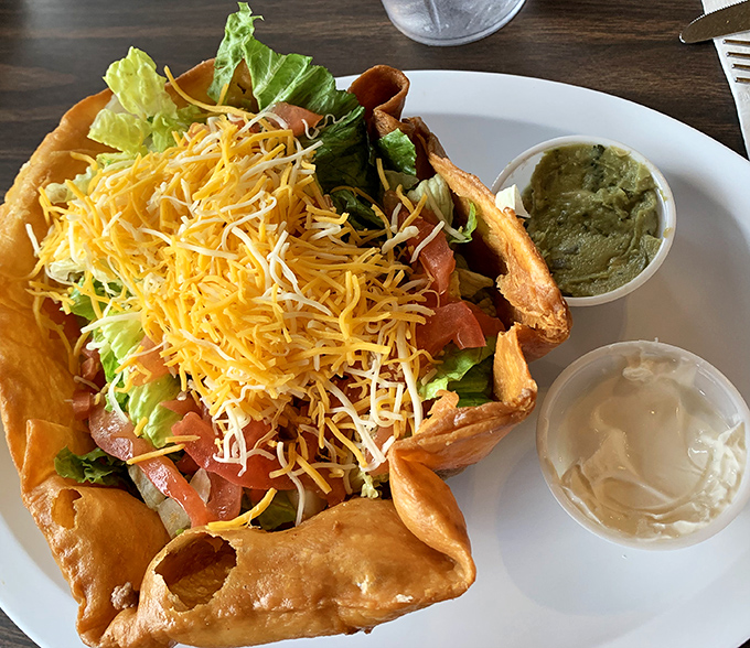 A taco salad that refuses to be a boring health food &ndash; that fried shell is basically saying, "Yes, there's lettuce, but we're still having fun here."