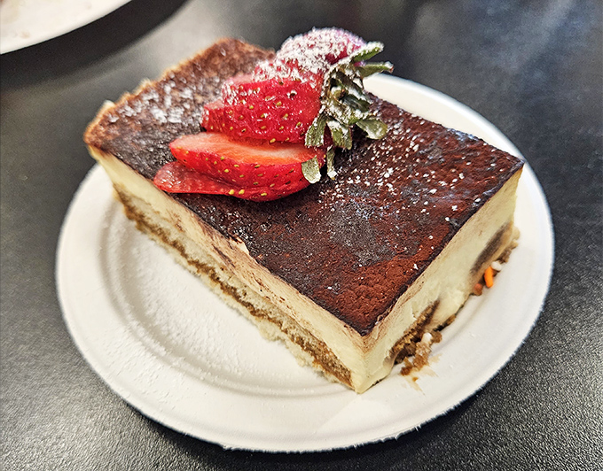 Tiramisu that strikes the perfect balance between coffee intensity and creamy indulgence. That strawberry isn't decoration&mdash;it's the cherry on top that isn't a cherry.