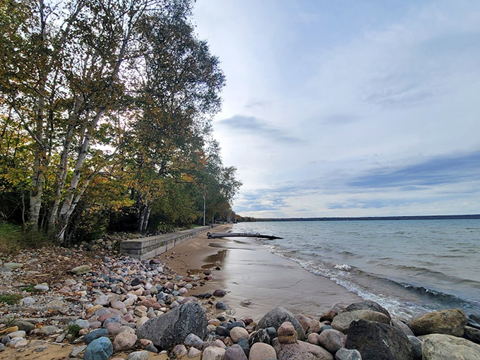Fall's early brushstrokes paint Brimley's shoreline with hints of amber and gold, framing Superior's endless blue canvas.