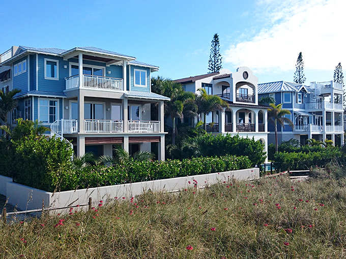 Pastel-colored beach homes stand like a row of tropical treats. Architectural eye candy that somehow survived Florida's condo fever.