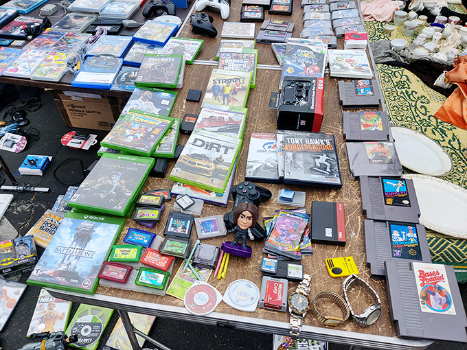 Gaming history laid bare on a wooden table. From Atari to Xbox, this nostalgic spread of video games spans generations of button-mashing memories.