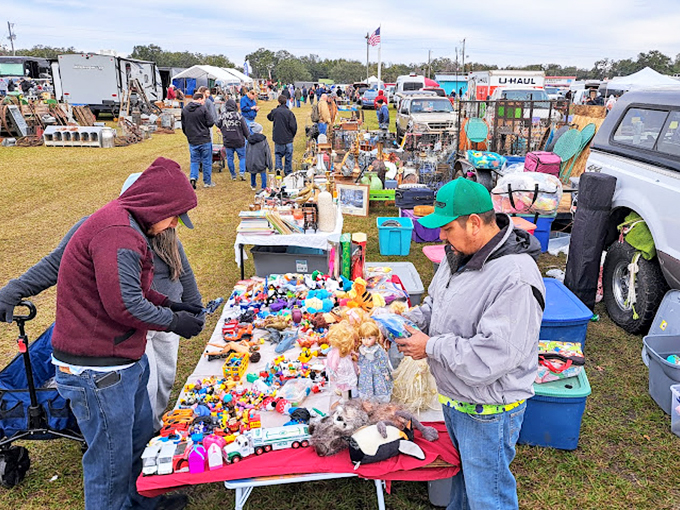 The universal language of bargain hunting in action. Shoppers examine vintage toys with the concentration of archaeologists at a promising dig site.
