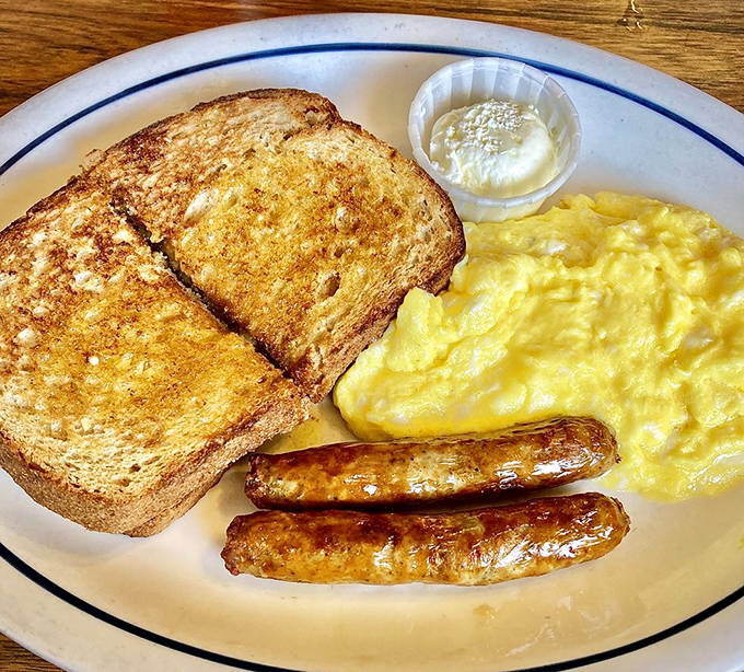 Eggs, sausage, and toast arranged like they're posing for their high school yearbook photo.