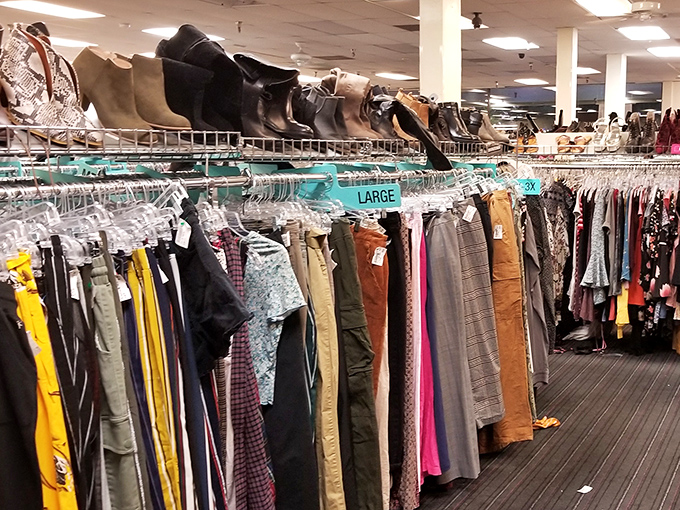 Above, rows of boots stand like stylish sentinels; below, racks of color and pattern line the path&mdash;thrift shopping&rsquo;s version of a runway waiting for its star.