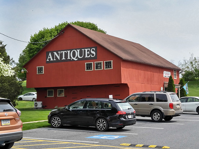 This classic red barn screams "authentic Pennsylvania antiques" louder than a rooster at dawn.