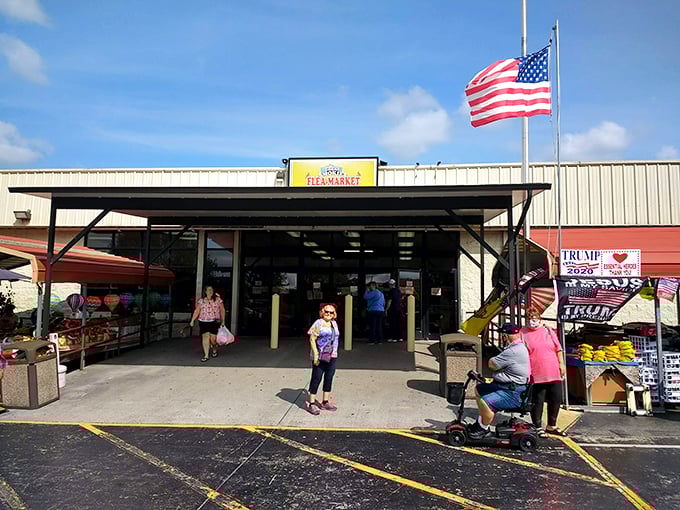 American flag flying high over serious flea market business - patriotism meets treasure hunting perfectly.