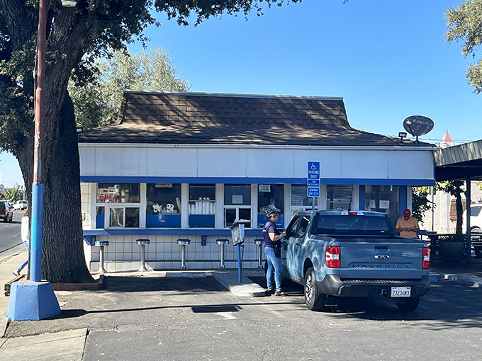 That blue and white facade screams classic Americana, where drive-in dreams and perfect burgers still come true.
