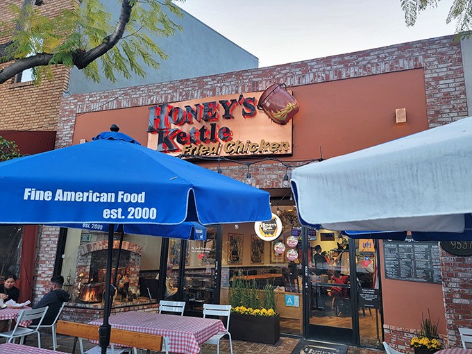 Honey's Kettle's brick charm and twinkling lights create the perfect backdrop for their legendary fried chicken experience.