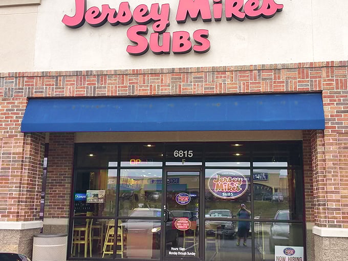Jersey Mike's bright signage cuts through strip mall anonymity like their fresh-sliced meats cut through hunger.