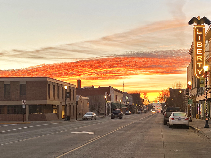 A quiet street in La Grande basks in the glow of a sunset sky, with the Liberty Theatre sign standing proud as a beacon of the town’s enduring charm.