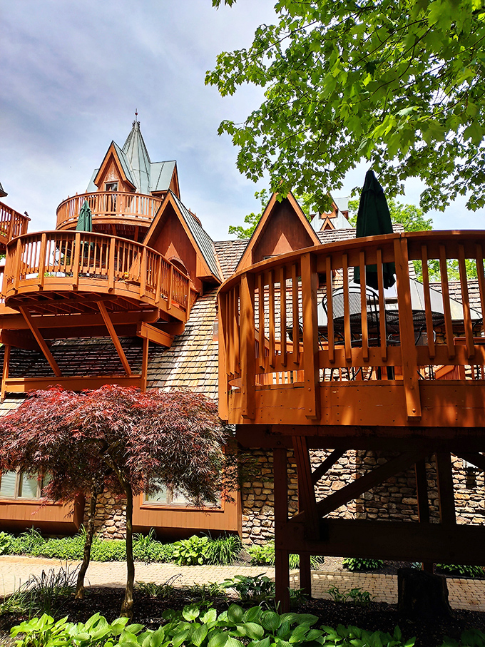 Wooden balconies and stone foundations create architectural poetry among Ohio's peaceful Mohican forest canopy.