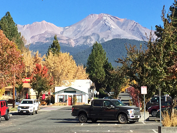 The majestic Mount Shasta looms over the town, its snowy peak a breathtaking backdrop to a clear day.