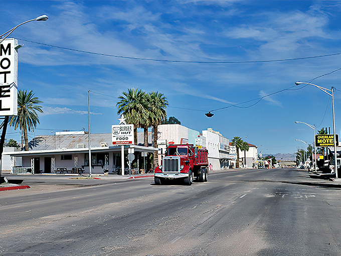 The wide-open streets of Needles offer a glimpse of desert living where palm trees meet blue skies.