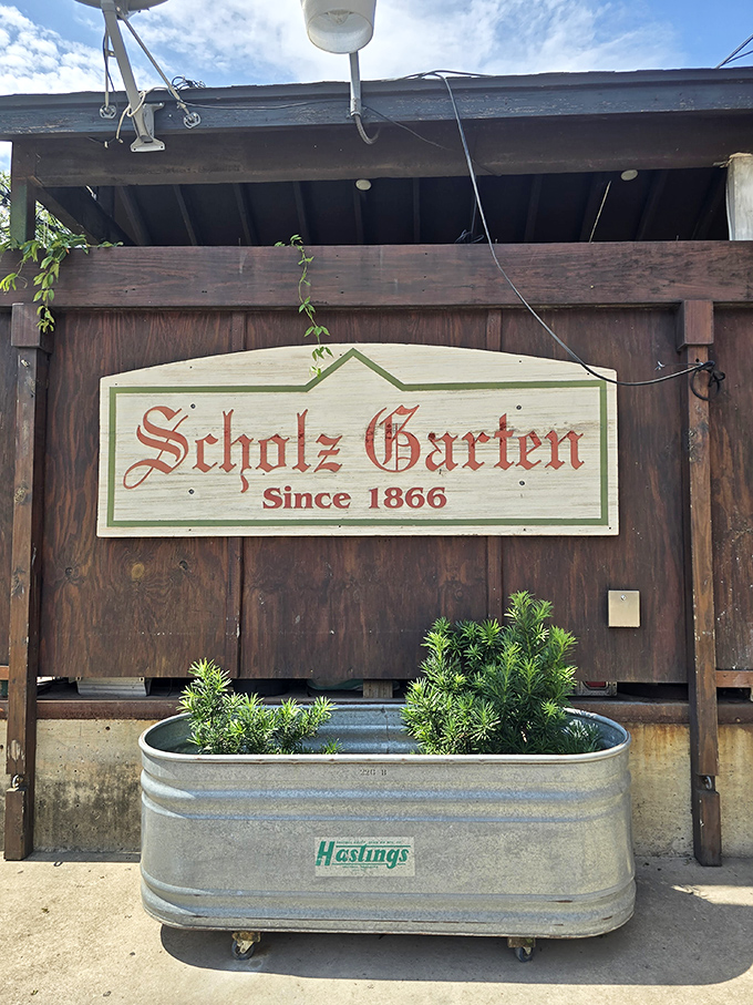 Scholz Garten's historic sign promises a taste of Texas tradition - they've been perfecting the beer garden since 1866!