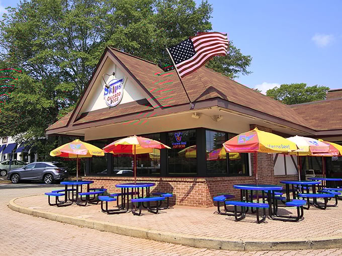 Brick, umbrellas, and outdoor seating create the perfect recipe for leisurely hot dog enjoyment.