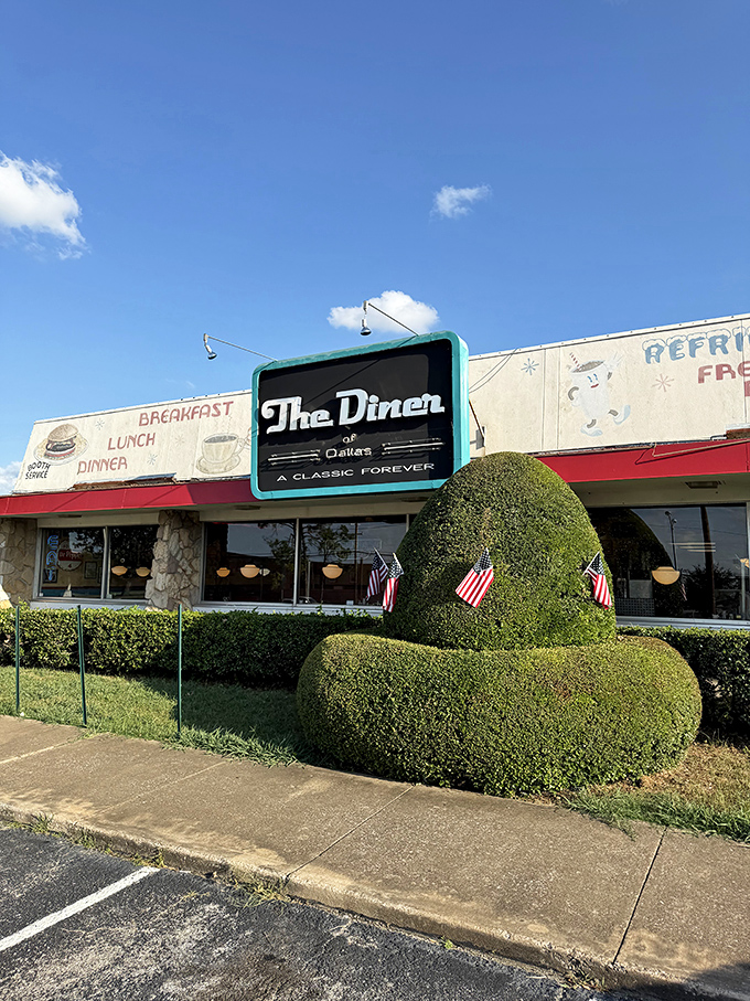 The Diner's vintage facade and perfectly manicured hedges scream "classic Americana" before you even taste the food.