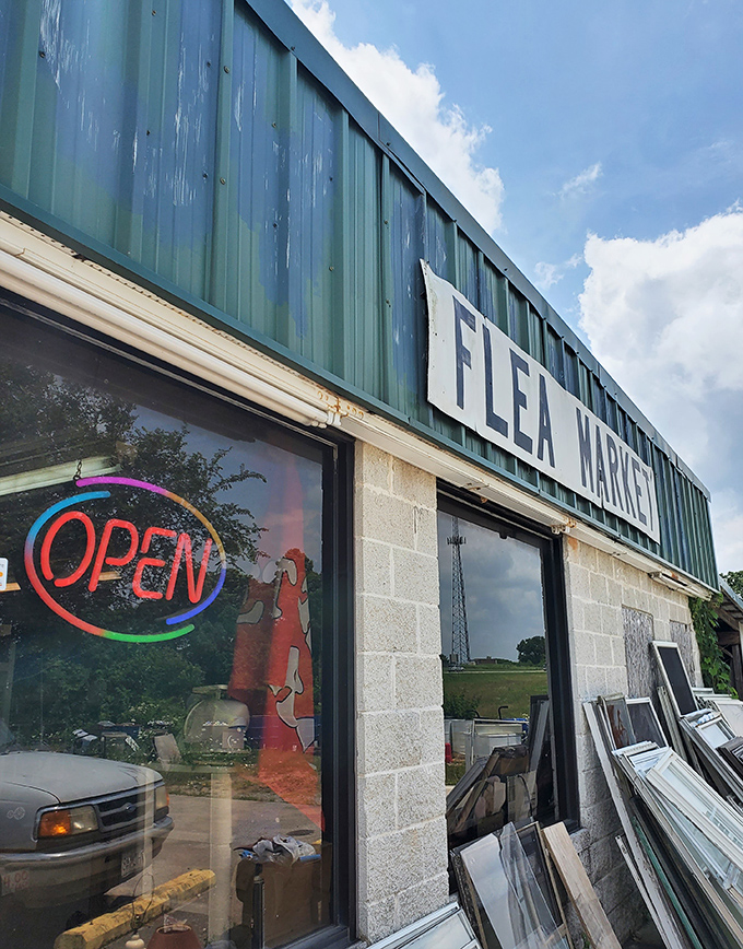 That simple "Flea Market" sign and neon "Open" light promise honest deals and genuine discoveries ahead.