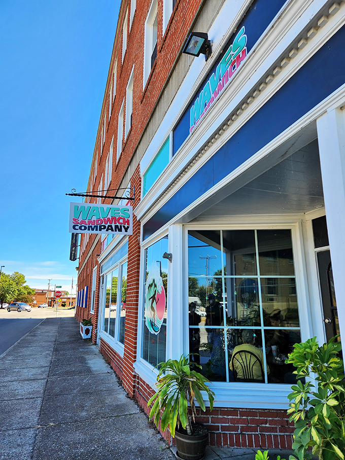 Waves Sandwich Company brings beach vibes to downtown with its bright blue sign. Surfboards and sandwiches &ndash; an unexpected perfect pairing.