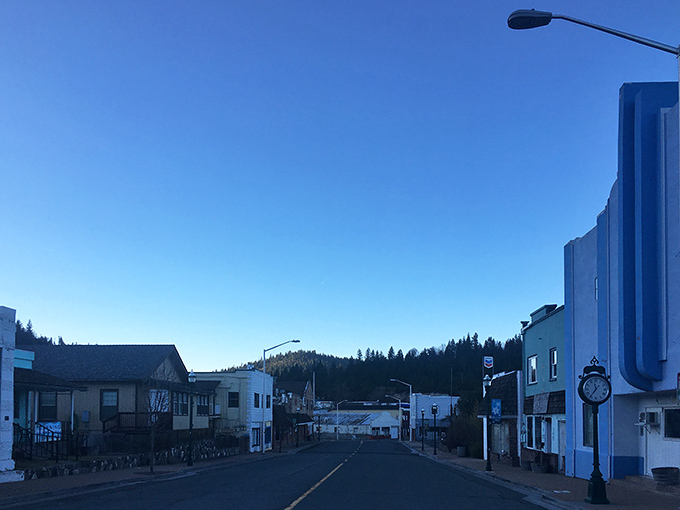Empty promise! Weed's quiet street stretches toward tree-covered hills like an invitation to a slower pace where "rush hour" means three cars at the stop sign.