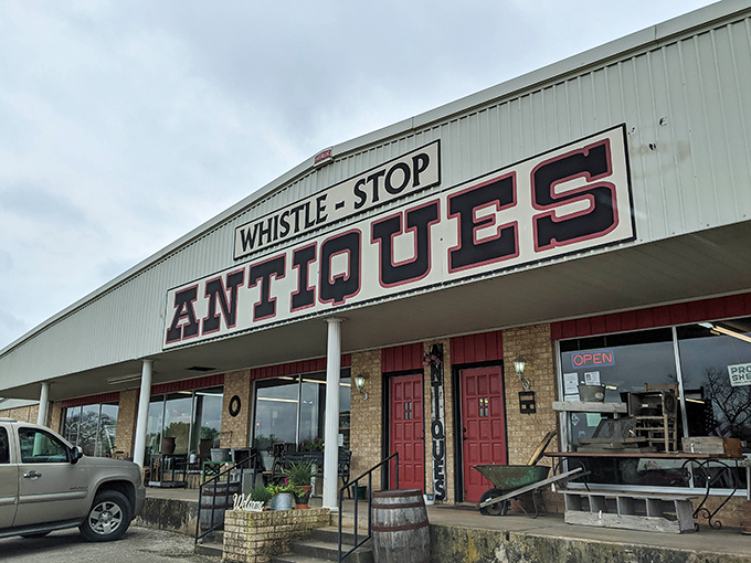 Whistle Stop's bold signage stands out against the Texas sky. Those red doors aren't just entrances—they're portals to affordable vintage adventures!