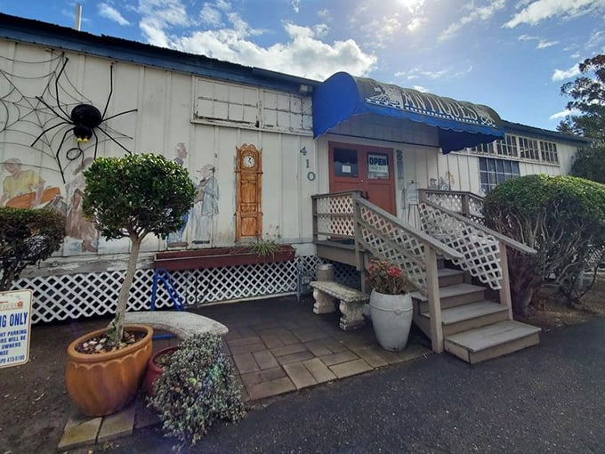 Whimsical decorations and a charming blue awning hint at the wonderland of antiques waiting inside.