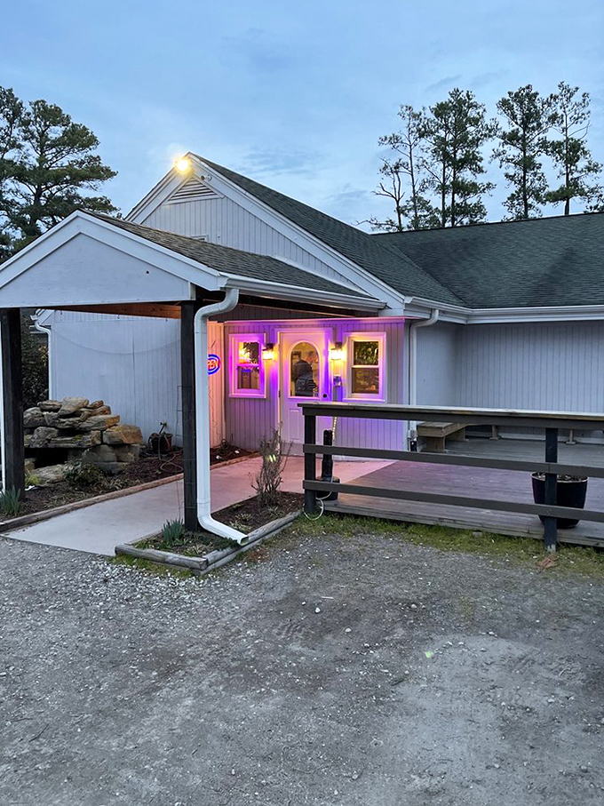 Purple neon glow against evening sky creates an almost mystical atmosphere for this hidden neighborhood treasure.