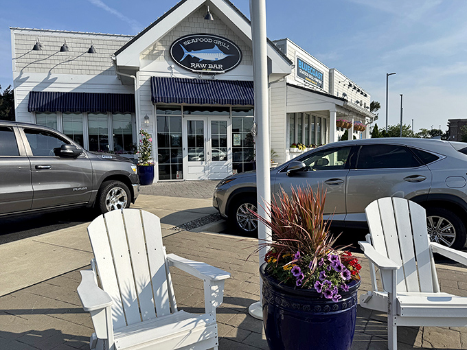 Those white Adirondack chairs suggest leisurely meals where dessert becomes the perfect finale to seaside dining adventures.