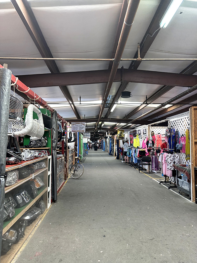 The well-organized layout features wide walkways where shoppers can easily navigate between clothing racks and antique displays.