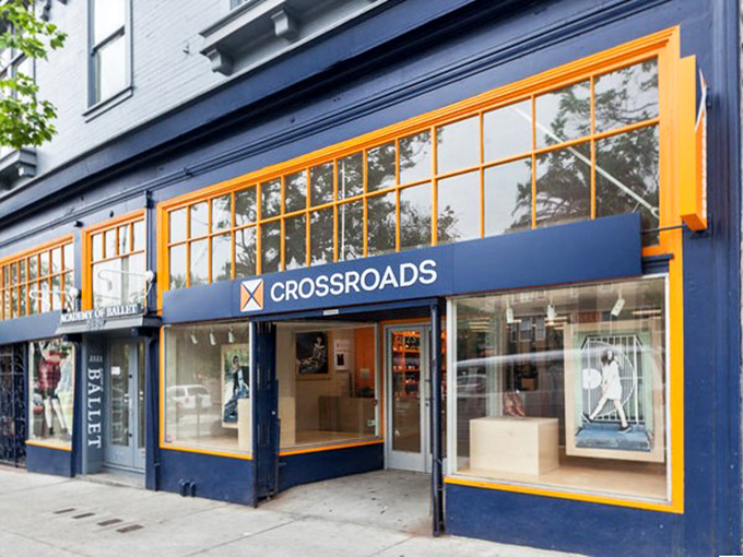 Those orange-trimmed windows frame fashion finds that blur the line between thrift and high-end retail.