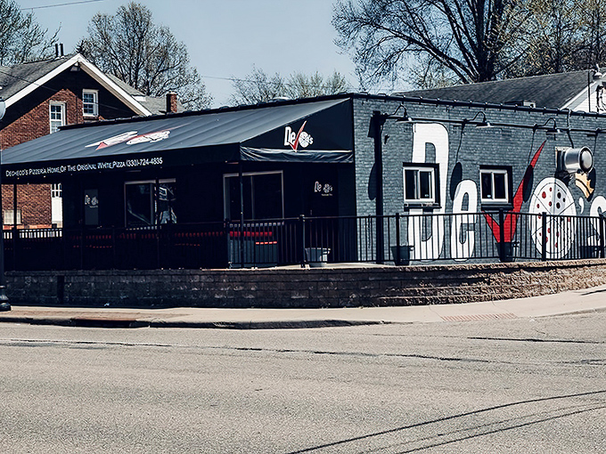 The bold red lettering against that modern facade promises contemporary pizza with old-school heart.