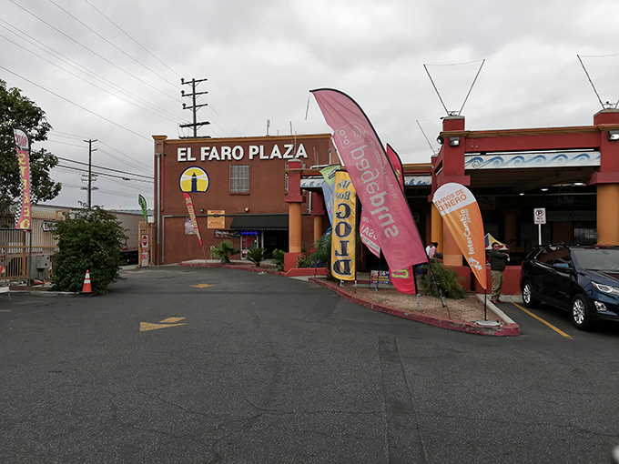 Colorful flags wave shoppers into El Faro Plaza, where bargains and local culture come together under one roof.