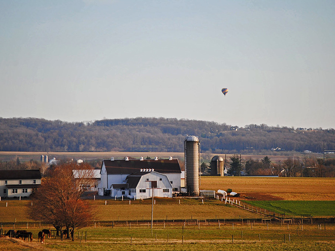 Hot air balloons drift overhead like colorful dreams, adding magic to an already perfect landscape.