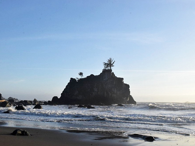 The lonely silhouette of Hidden Beach's iconic rock formation stands like a sculpture against the morning light.