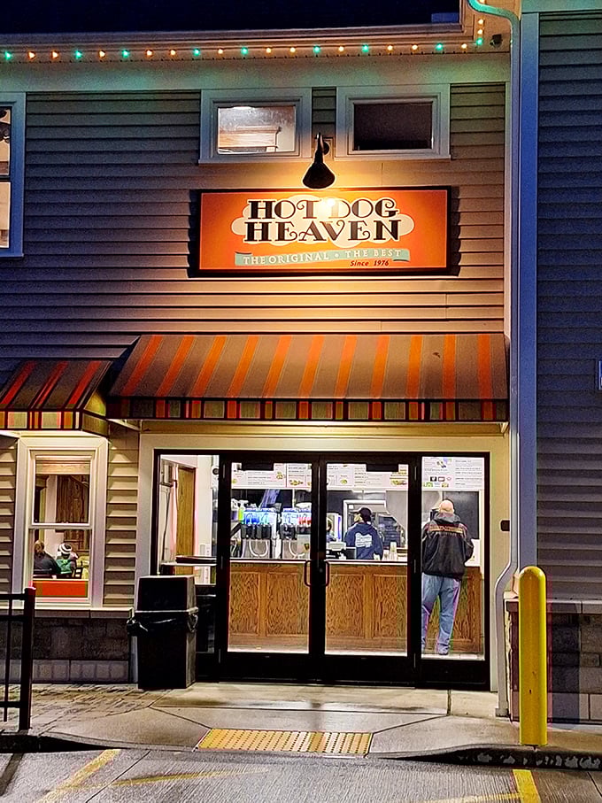 Evening lights transform this cozy spot into a warm beacon for hot dog lovers seeking heavenly satisfaction.