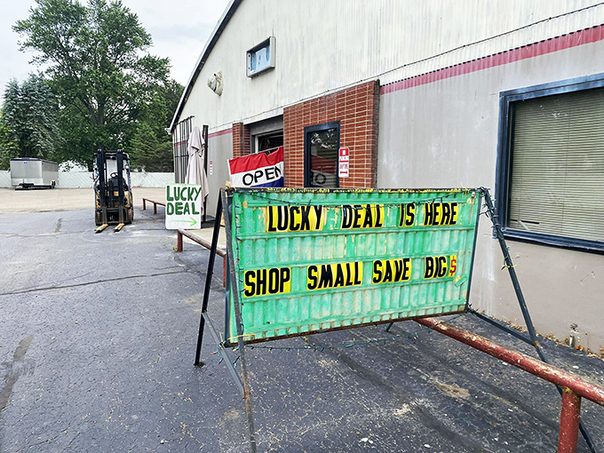 Hand-painted signs announce deals with the enthusiasm of a carnival barker welcoming treasure hunters.