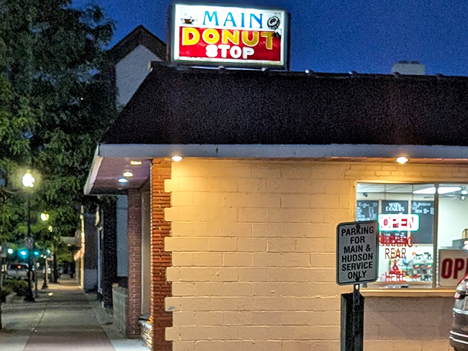 As evening falls, this little donut shop glows like a lighthouse guiding sugar-seekers safely to shore.