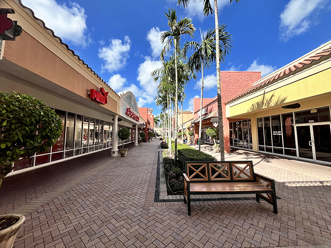 Palm-lined walkways guide you between tempting storefronts. The grass is always greener where the deals are sweeter.
