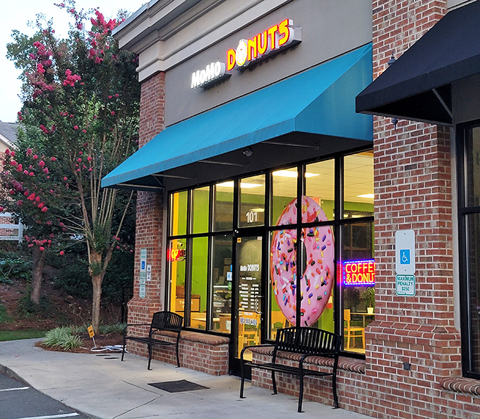 Blue skies, blue awnings! MoMo's inviting storefront with flowering trees creates the perfect setting for donut diplomacy.