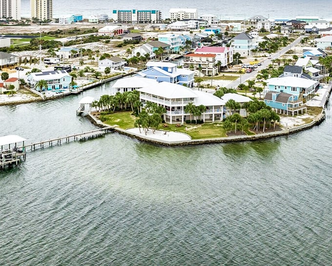 Navarre Beach's colorful waterfront homes perch on stilts above the gentle waters, a scene straight from old Florida's dreamy past.