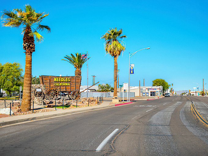 Needles welcomes visitors with its vintage sign and palm trees, a desert oasis for budget-conscious retirees.