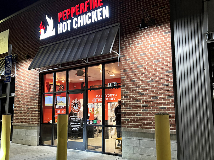 The Pepperfire storefront glows like a spicy beacon in the night. Those yellow safety poles aren't just for cars&mdash;they're to hold you up after the heat hits!