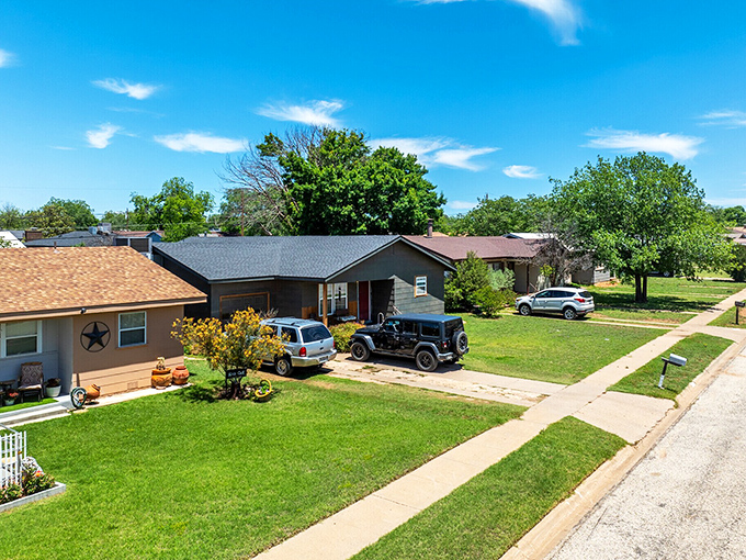 The wide street and local businesses create an inviting atmosphere where neighbors still know each other.