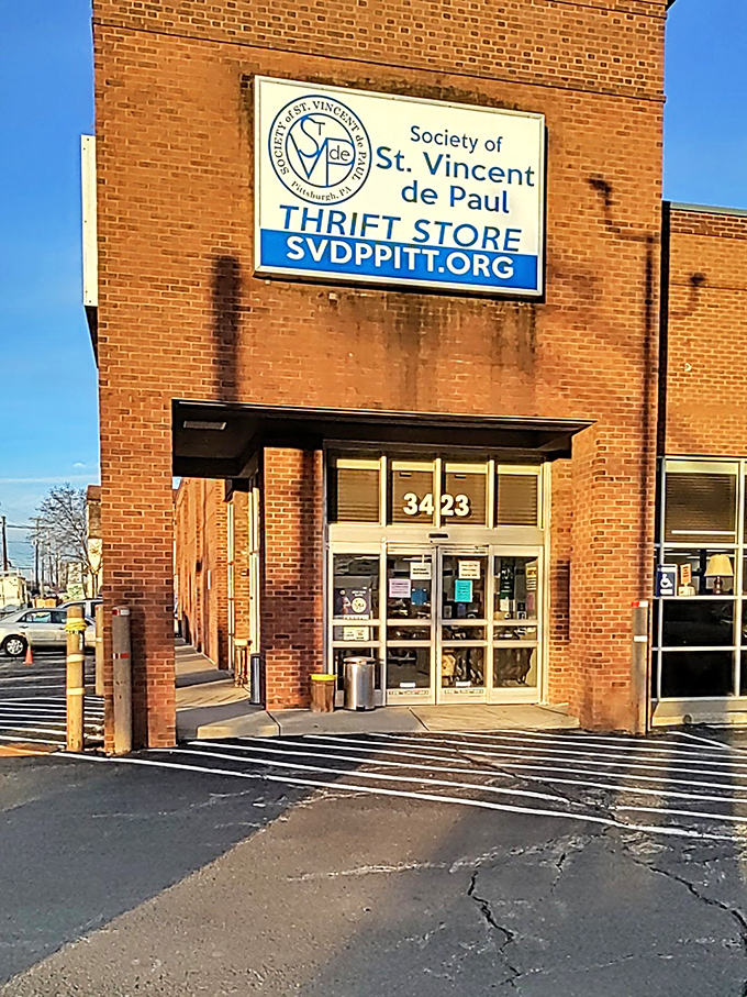 Sunlight catches the St. Vincent de Paul sign, welcoming treasure seekers. This Pittsburgh landmark has saved budgets for generations.