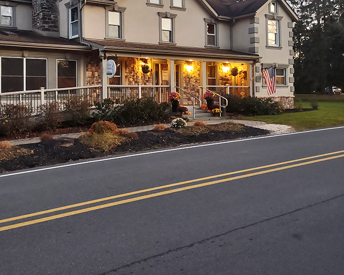Evening lights warm this stone house where seafood gets the royal treatment. Comfort meets luxury on every plate.